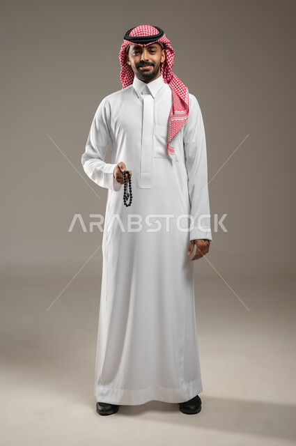 A full-length portrait of a Saudi Gulf Arab young man wearing the Saudi ...