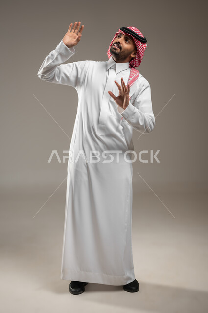 Fear and dread, a portrait of a Saudi Gulf Arab young man wearing Saudi ...