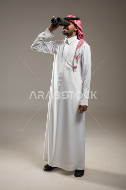 Portrait of a Saudi Gulf Arab man wearing Saudi uniform, looking at ...