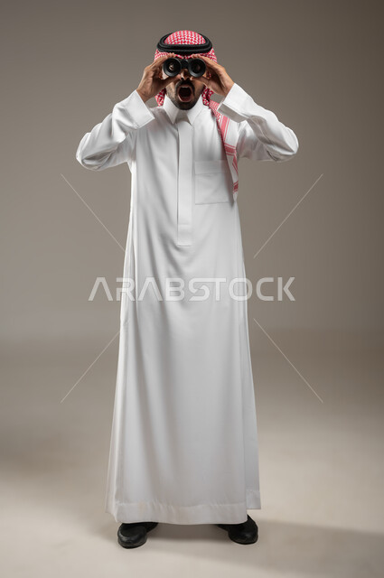 Portrait of a Saudi Gulf Arab man wearing Saudi uniform, looking at ...