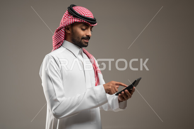 A close-up portrait of a Saudi Gulf Arab man wearing Saudi uniform ...
