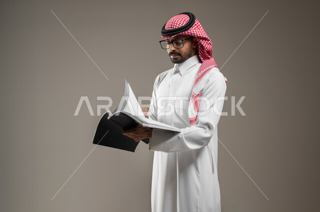 Love of reading and studying, close-up portrait of a Saudi Gulf Arab ...