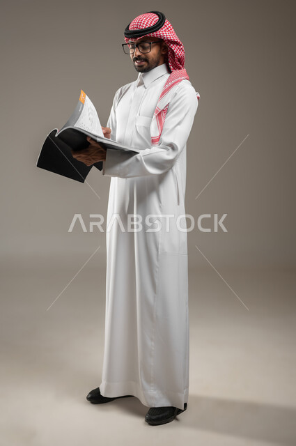 Love of reading and reading, portrait of a Saudi Gulf Arab man flipping ...