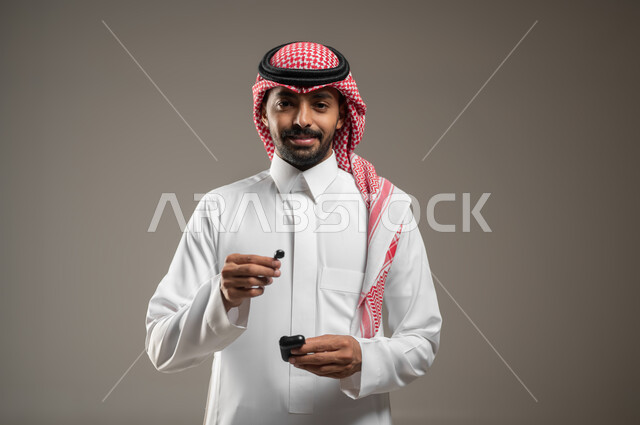 A close-up portrait of a Saudi Arabian Gulf man wearing a Saudi uniform ...