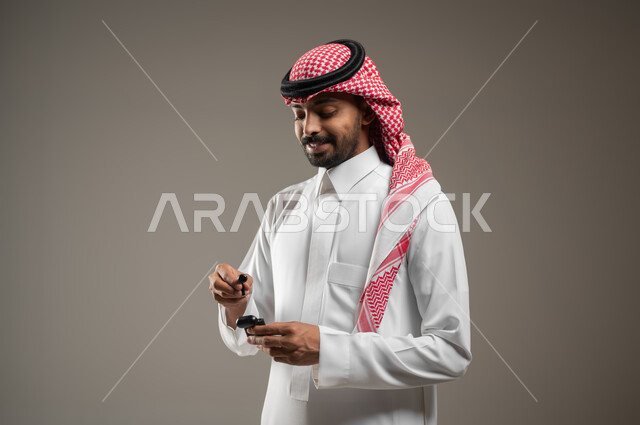 A close-up portrait of a Saudi Arabian Gulf man wearing a Saudi uniform ...