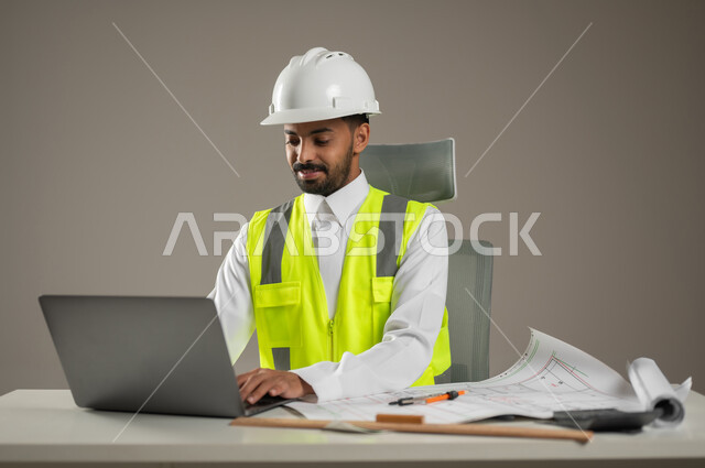 Completing work tasks remotely, a close-up portrait of a Saudi Arabian ...