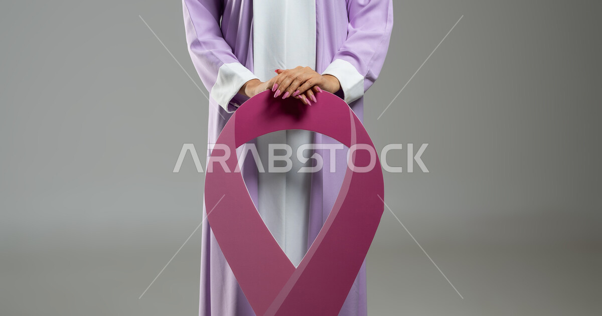 World Breast Cancer Awareness Day, portrait of a smiling, veiled Saudi ...