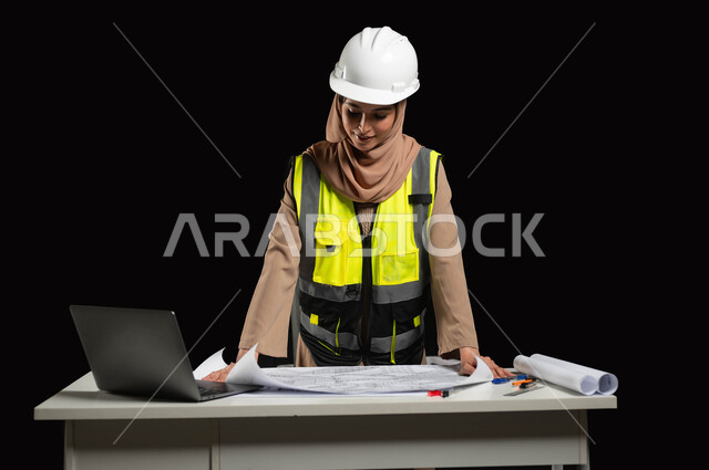 Engineering professions and jobs, auditing engineering plans, close-up portrait of a Saudi ...