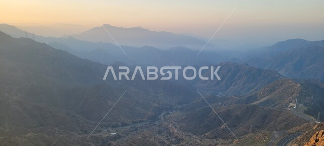 View of the foggy sky at sunset over the mountains in Abha, famous ...