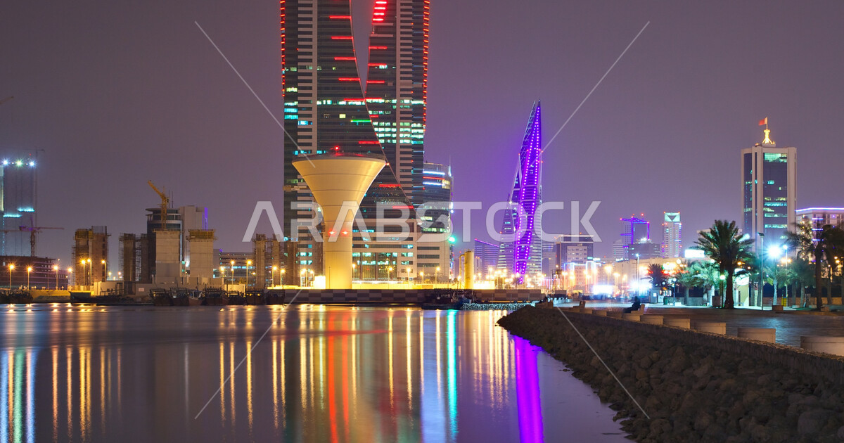 The illuminated financial harbor overlooking the coast of the Arabian ...