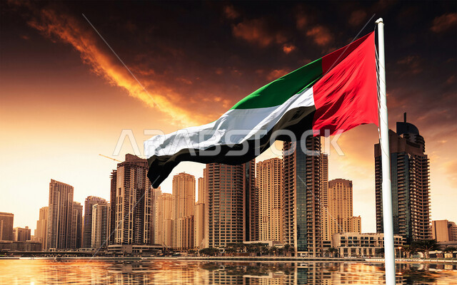 The flag of the United Arab Emirates flying in the sky, aerial ...