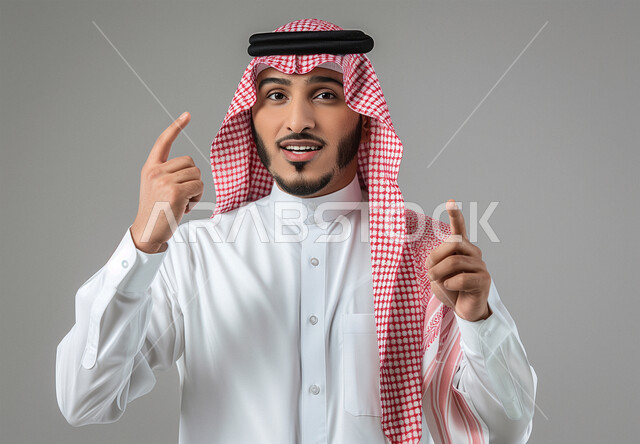 Pointing to something, a close-up portrait of a Saudi Gulf Arab man ...