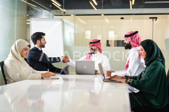 A business meeting between Saudi Gulf Arab employees in the meeting ...