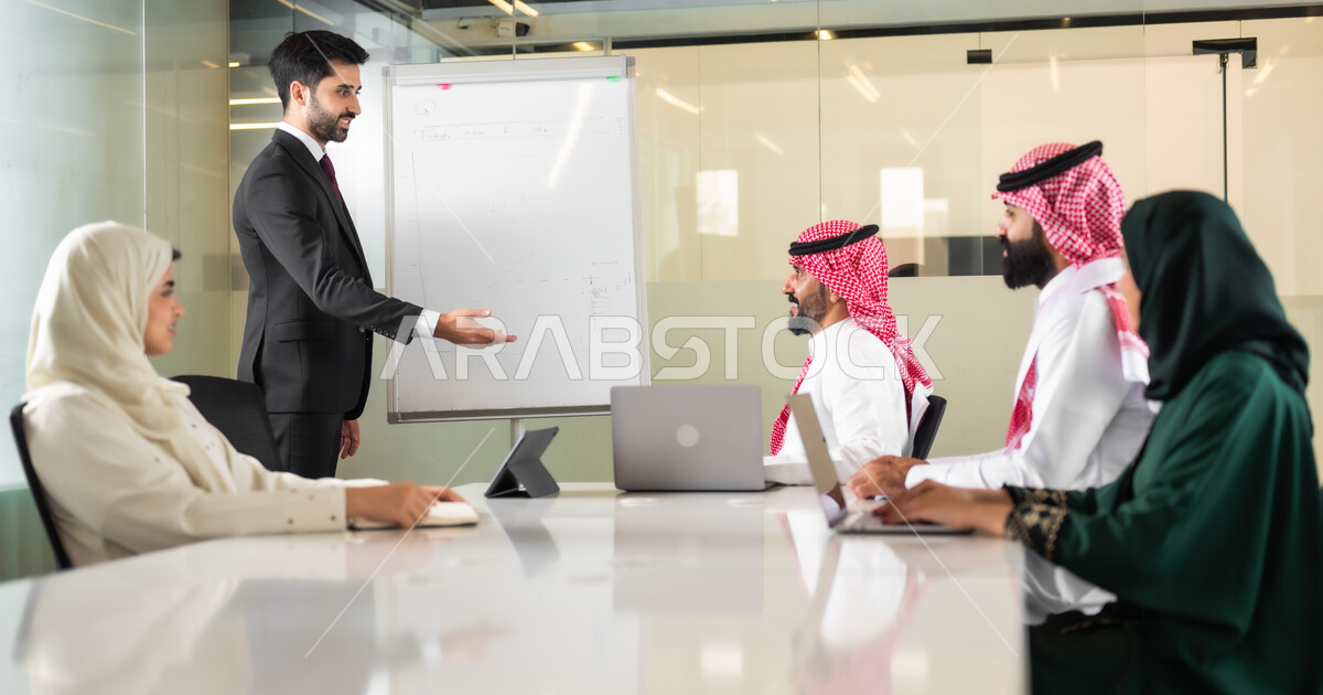 A business meeting between Saudi Gulf Arab employees in the meeting ...