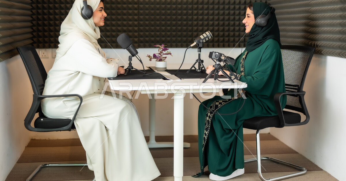Gestures of joy and happiness, two smiling veiled Arab Gulf women ...