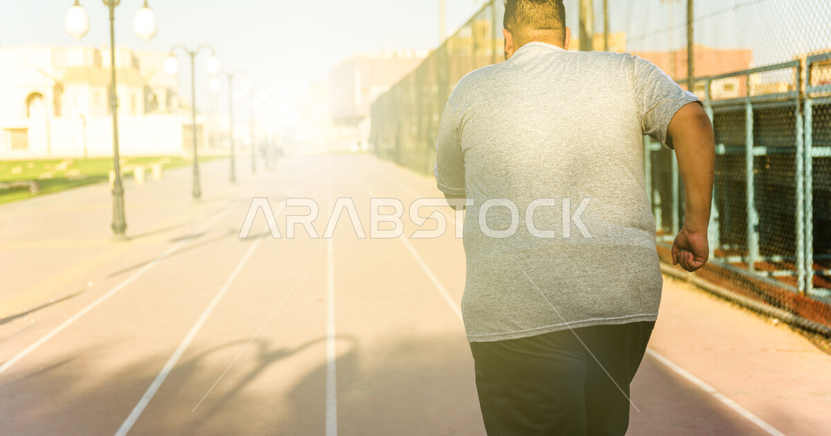 A young Saudi Gulf Arab practicing outdoor morning sports, walking ...