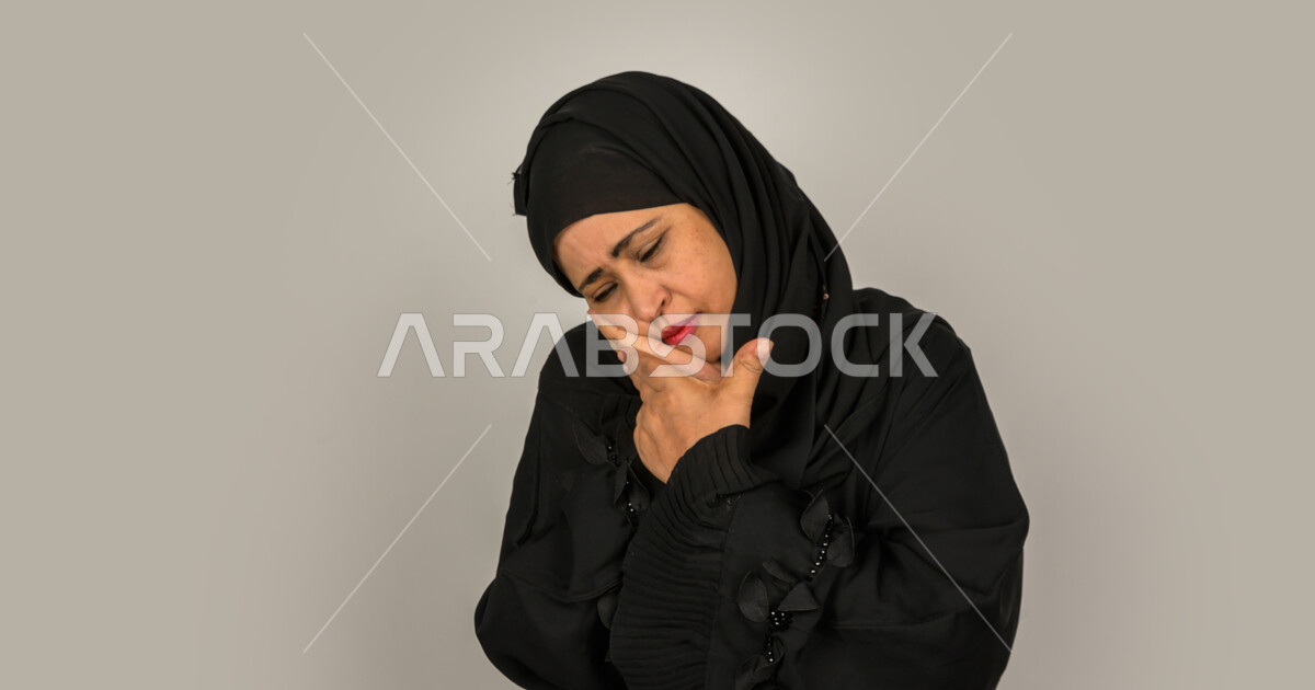Portrait of an elderly Saudi woman who is sick from the Gulf, with ...