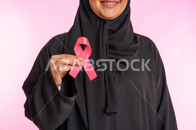 A Saudi woman holding the symbol of the global campaign, early ...