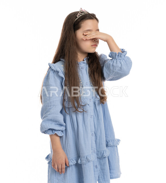 A Saudi girl wearing a dress feels tired, feeling lazy, lethargic and ...