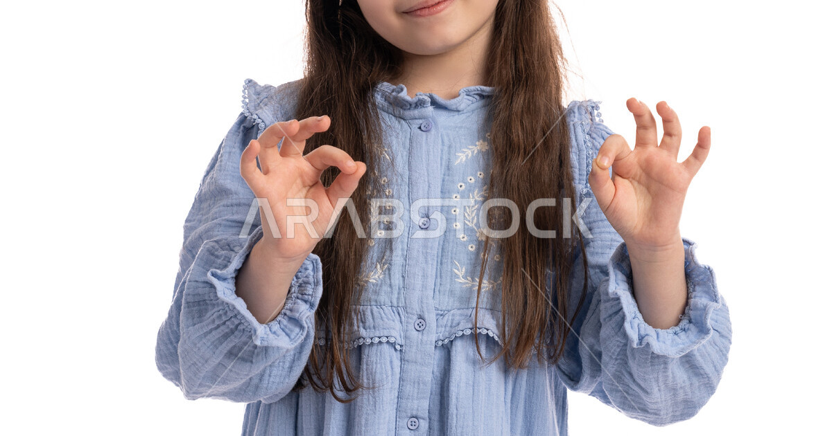 Expressions of approval and approval, a Saudi girl wearing a dress and ...