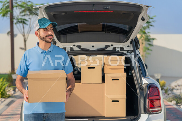 Order delivery representative, a young Arab Emirati Gulf man wearing ...