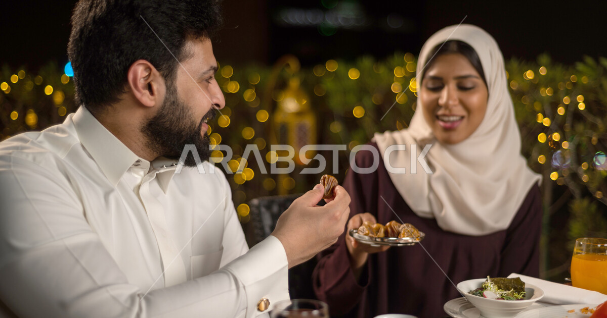 A Saudi Arabian couple at the breakfast table in the month of Ramadan ...