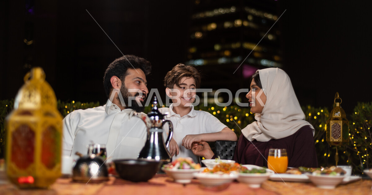 A happy Saudi Gulf family at the Iftar table in the month of Ramadan, a ...