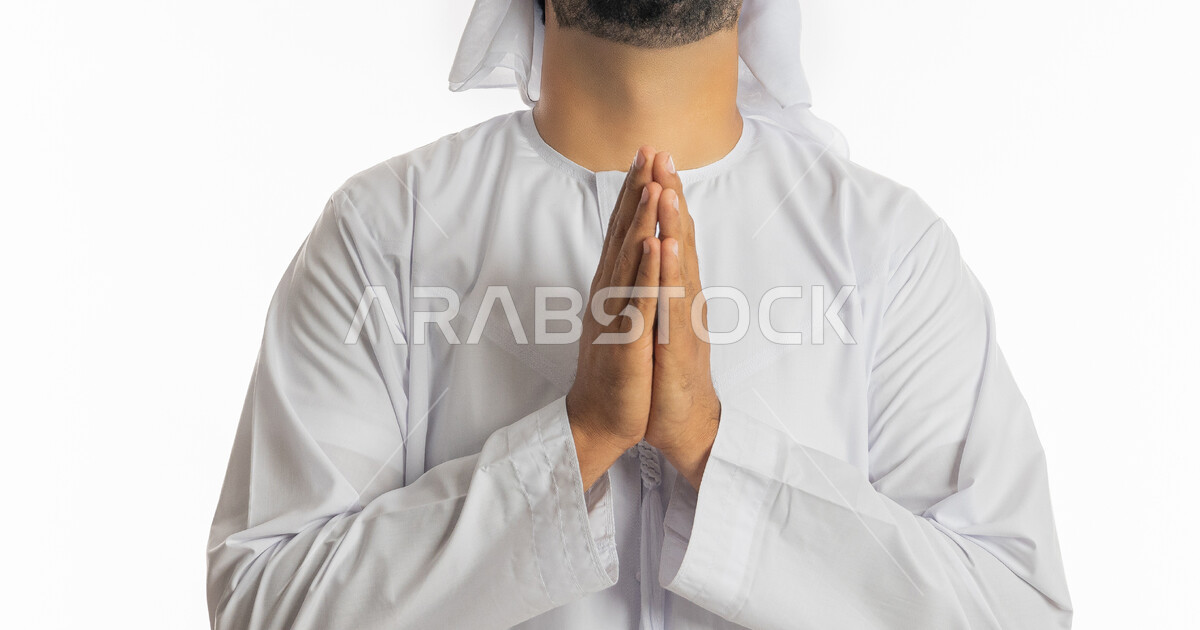 التضرع إلى الله تعالى, بورتريه مقرب لشاب عربي خليجي اماراتي مبتسم يرتدي العمامة والكندورة ...