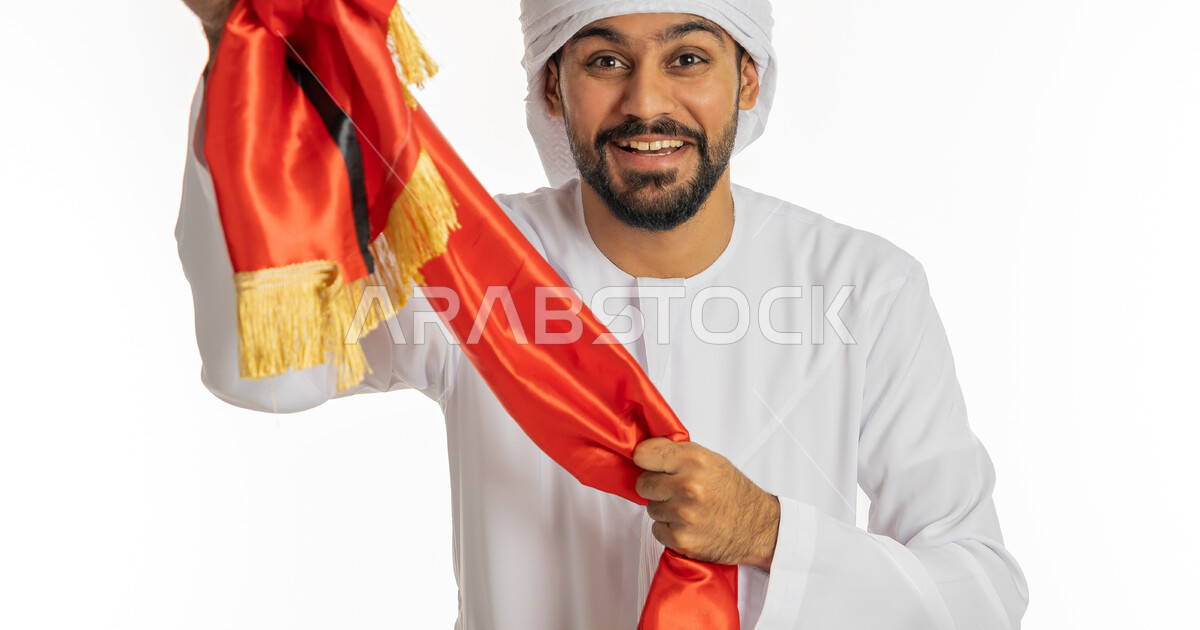Holding a red cheerleading scarf and looking at the camera with winning ...