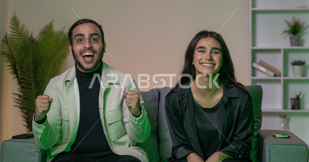Emirati team match, an Emirati Gulf Arab couple wearing casual clothes ...