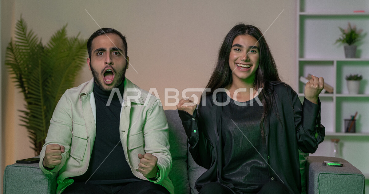 The Emirati football team, an Arab-Gulf Emirati couple wearing casual ...