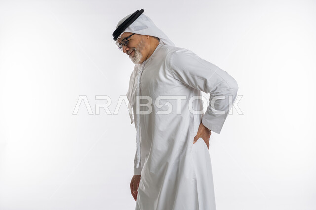Feeling pain in the spine, portrait of an elderly Arab, Gulf, Emirati ...