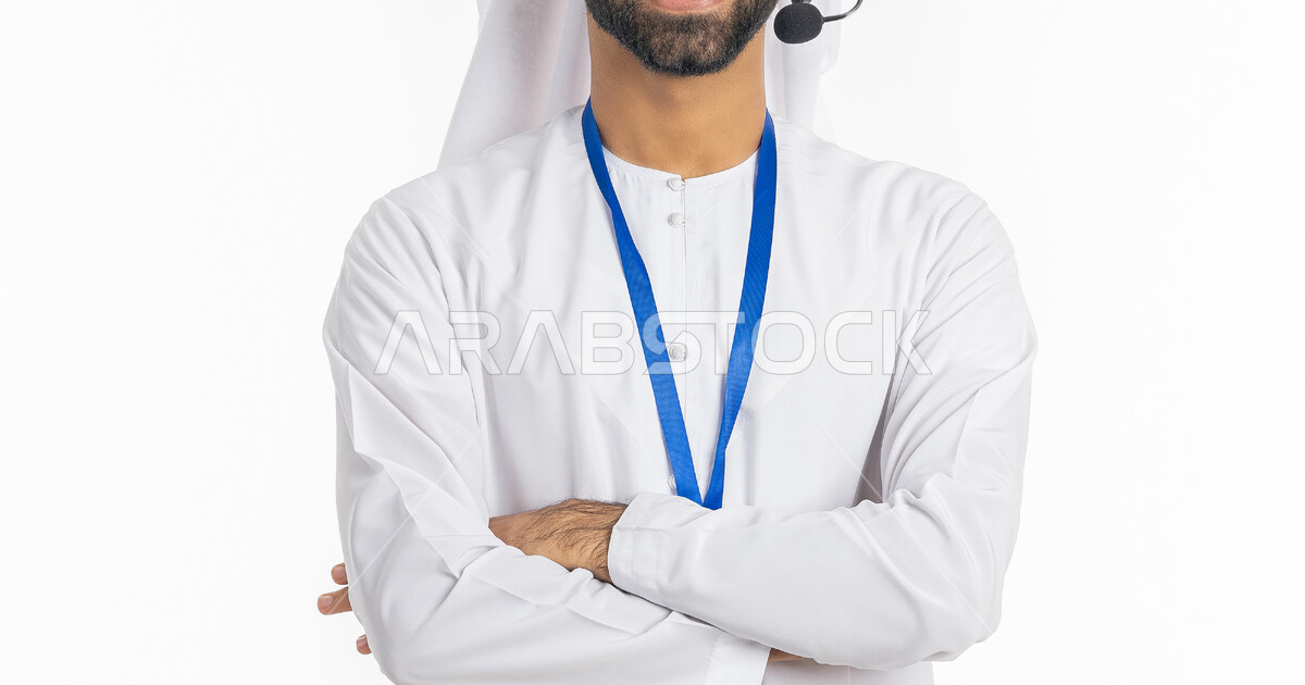Standing with crossed hand gestures, portrait of a smiling Emirati Gulf ...