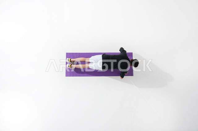 Various sports exercises, vertical overhead portrait of a Saudi Gulf ...