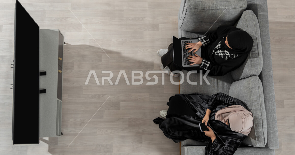 Spending time at home with friends, vertical portrait of two Saudi Gulf ...