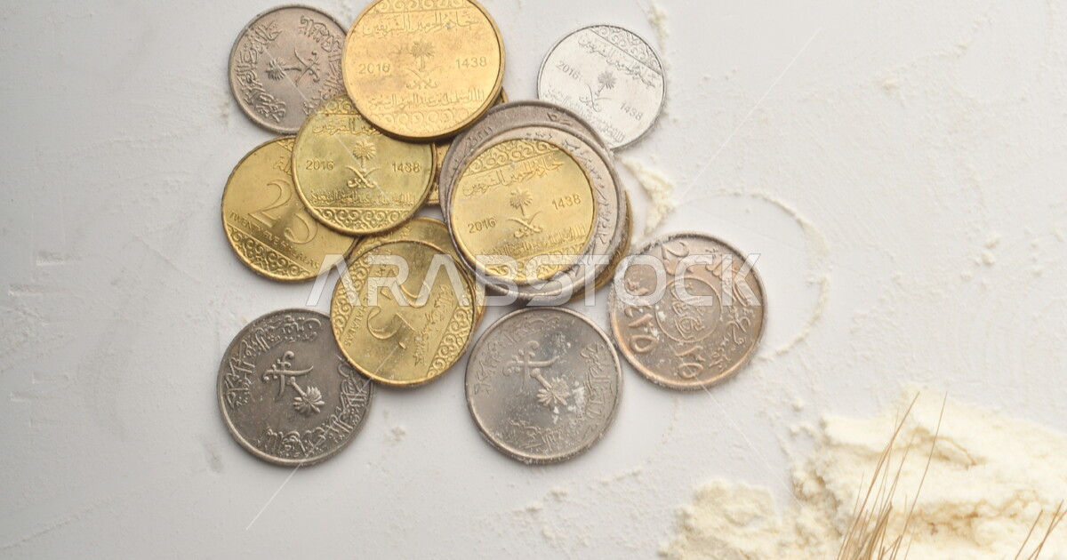 A group of rice , wheat, flour and coins depicted on a white background ...