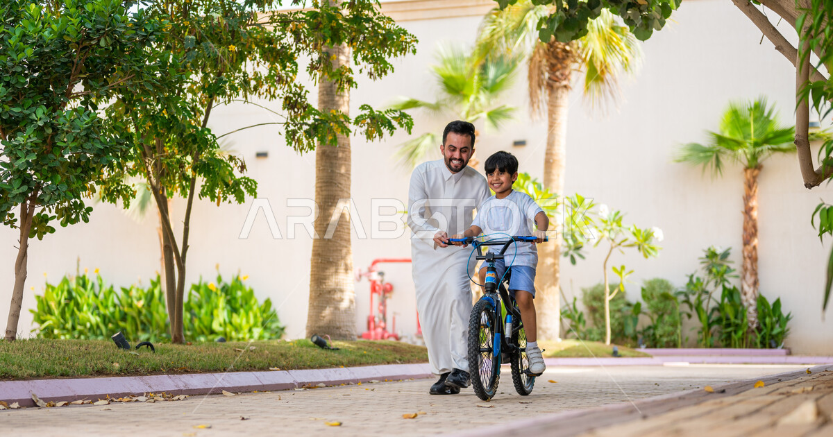 Entertaining entertainment activities, a Saudi Gulf Arab boy riding a ...