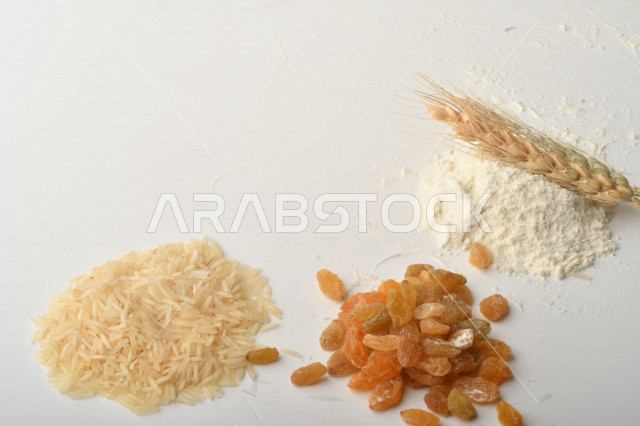 Handful of rice, wheat, raisins and flour on white background - Photo ...