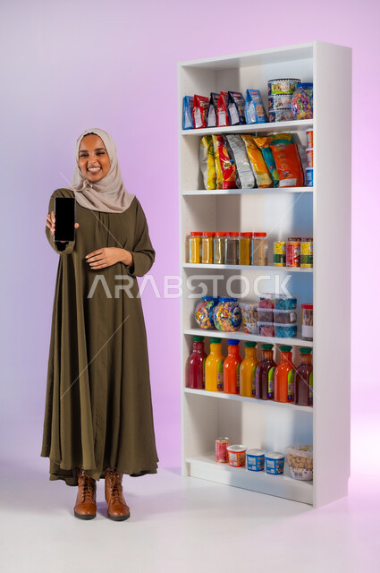 Enjoying shopping in the supermarket, portrait of a smiling Saudi ...