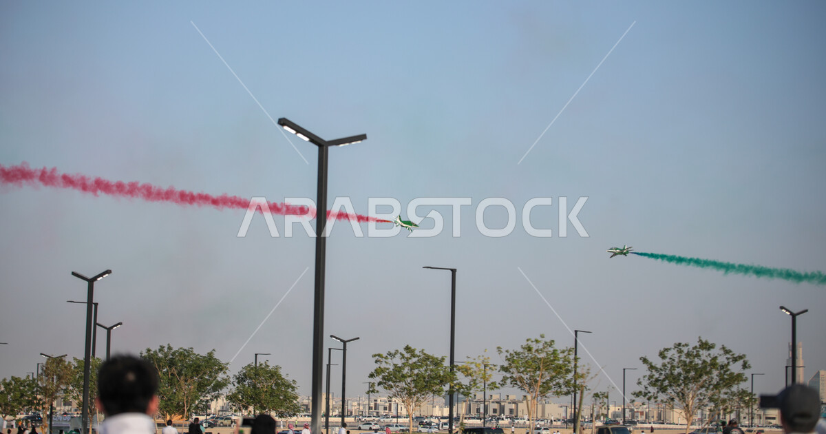 A group of citizens watching the Saudi National Day aviation team ...