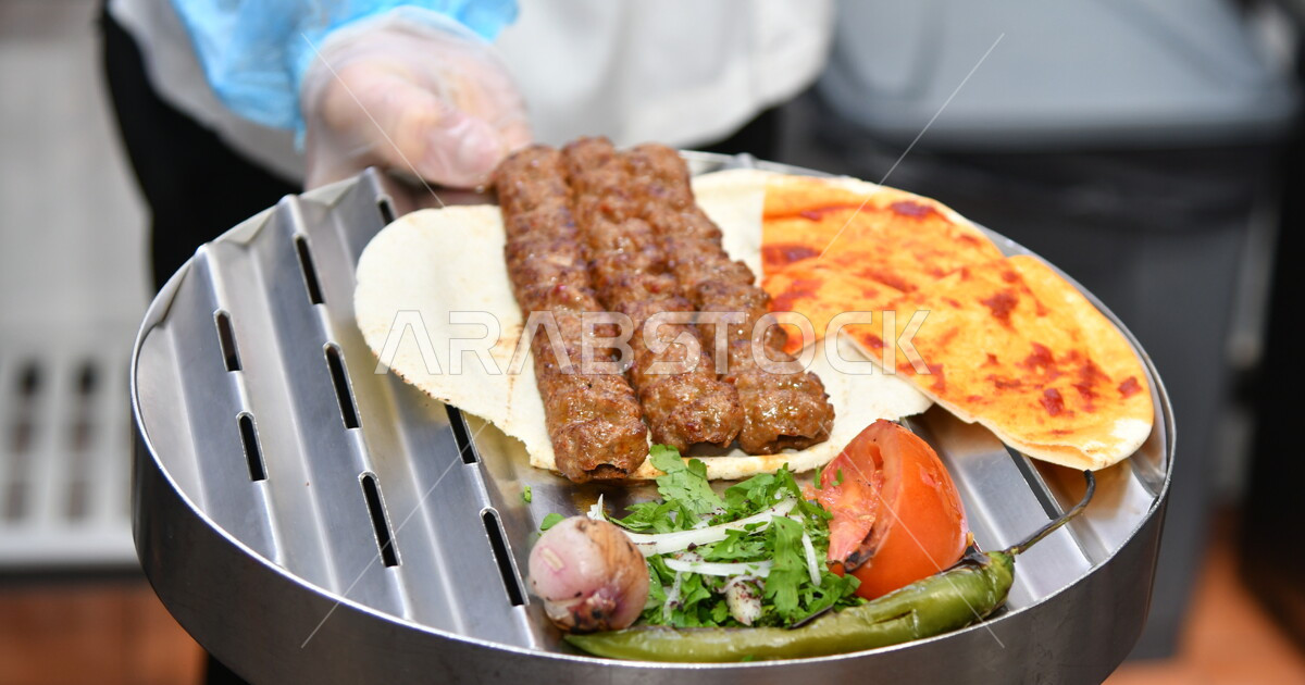 Fast and healthy meals, a close-up of the hand of a Saudi Arabian Gulf ...