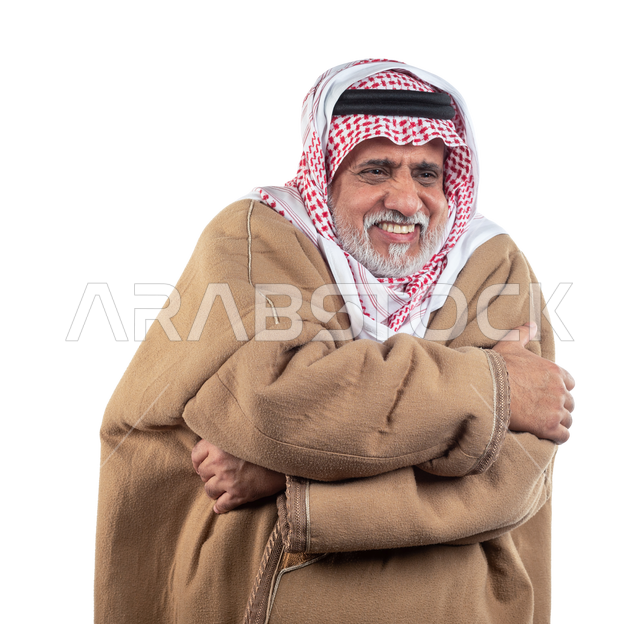 Portrait of an old Saudi Arab man feeling cold, wearing a Saudi bisht ...