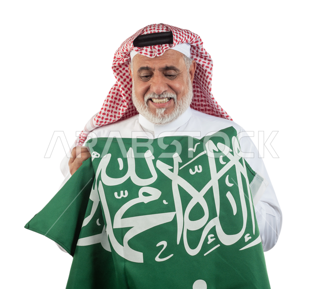 Portrait of an old Saudi Arab man holding the flag of Saudi Arabia and ...