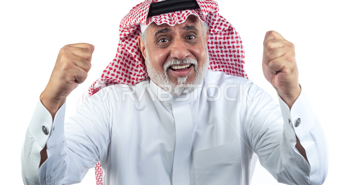 Portrait of an elderly Saudi Arab man raising his hands folded palms ...