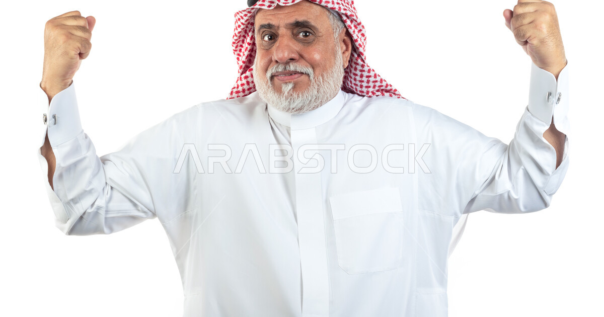 Portrait of an old Saudi Arab man doing the biceps movement, wearing a ...