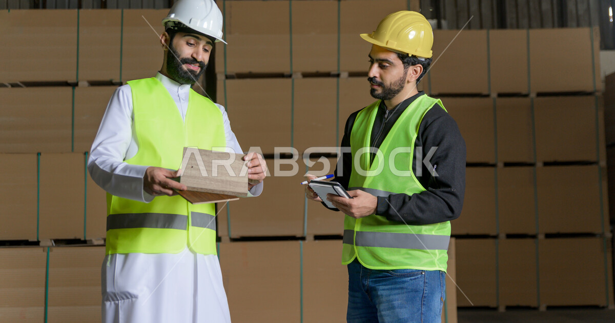 Two Saudi engineers working supervising inside the factory in Saudi ...