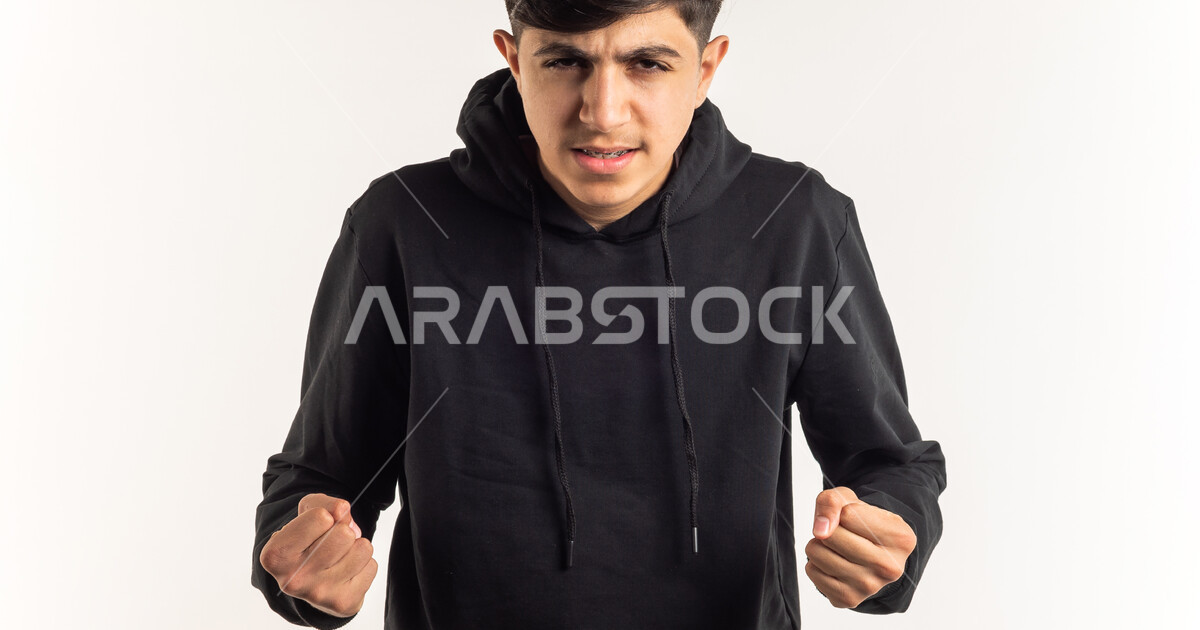 Portrait of a young Saudi Arabian Gulf teenager with different facial ...