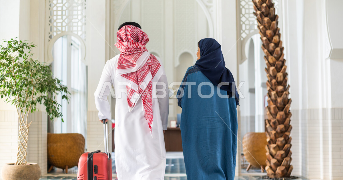 A Saudi couple, tourists, inside the tourist hotel, to spend the most ...
