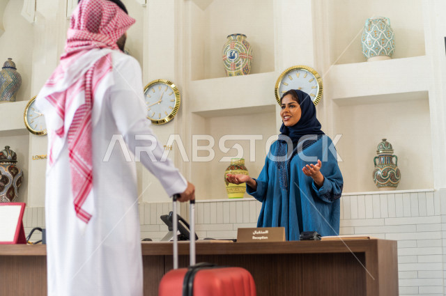 A veiled Saudi Gulf receptionist welcomes the Saudi guest at the ...