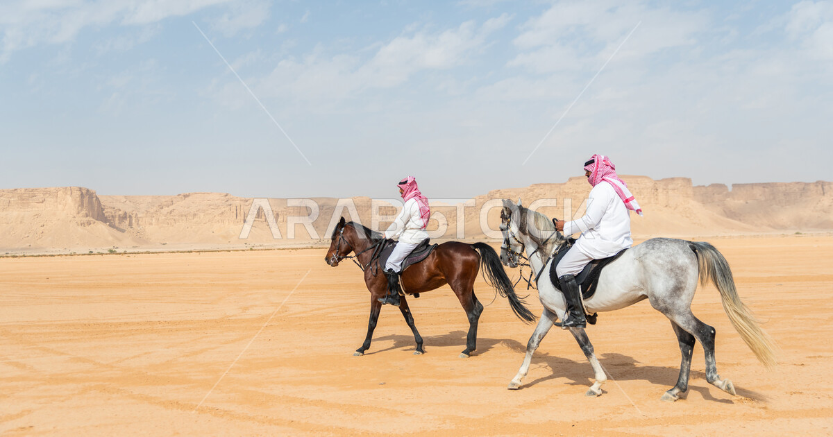 Two Saudi Arabian Gulf riders riding horses in the picturesque Saudi ...